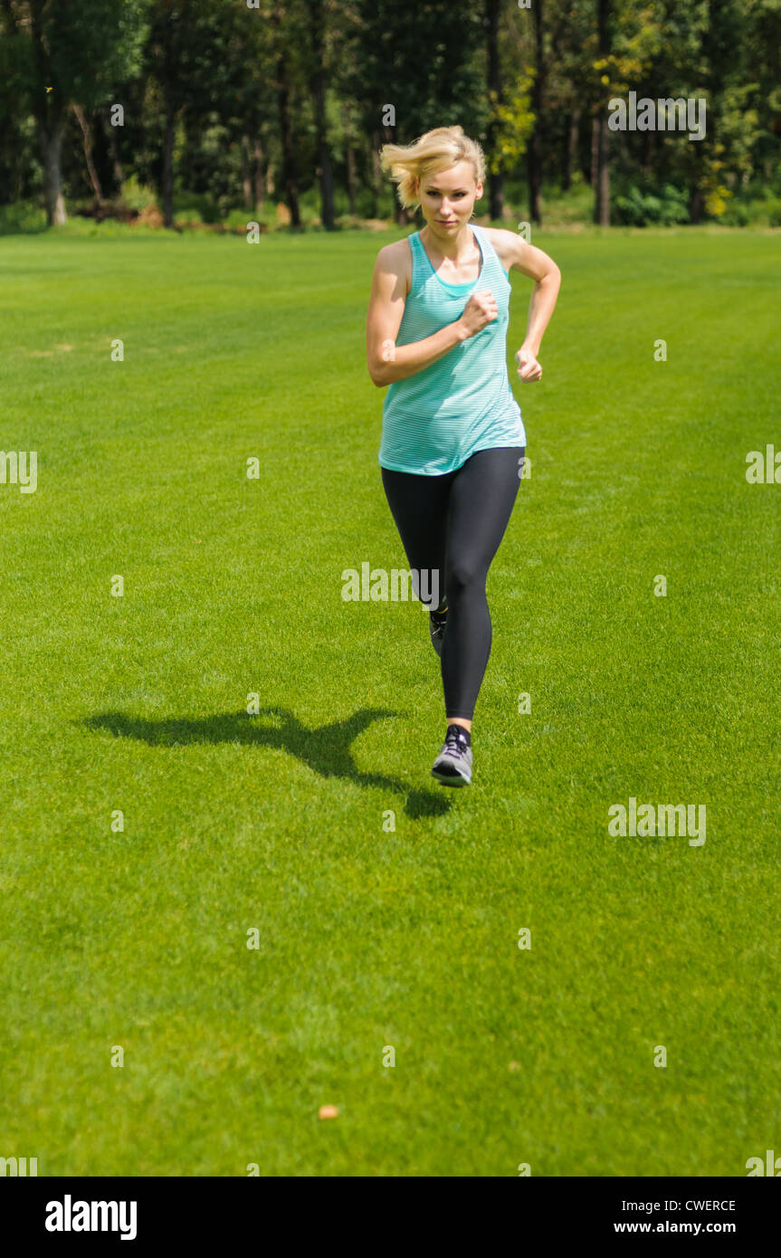An active beautiful caucasian woman running outdoor in a park Stock ...