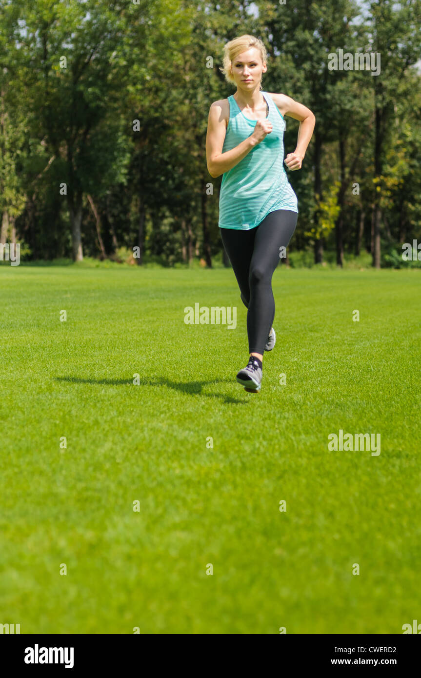 An active beautiful caucasian woman running outdoor in a park Stock ...
