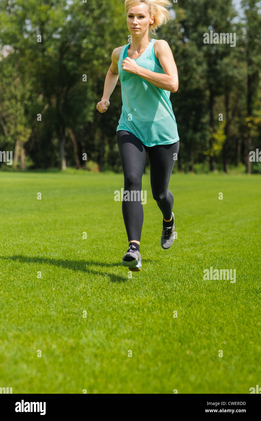 An active beautiful caucasian woman running outdoor in a park Stock ...