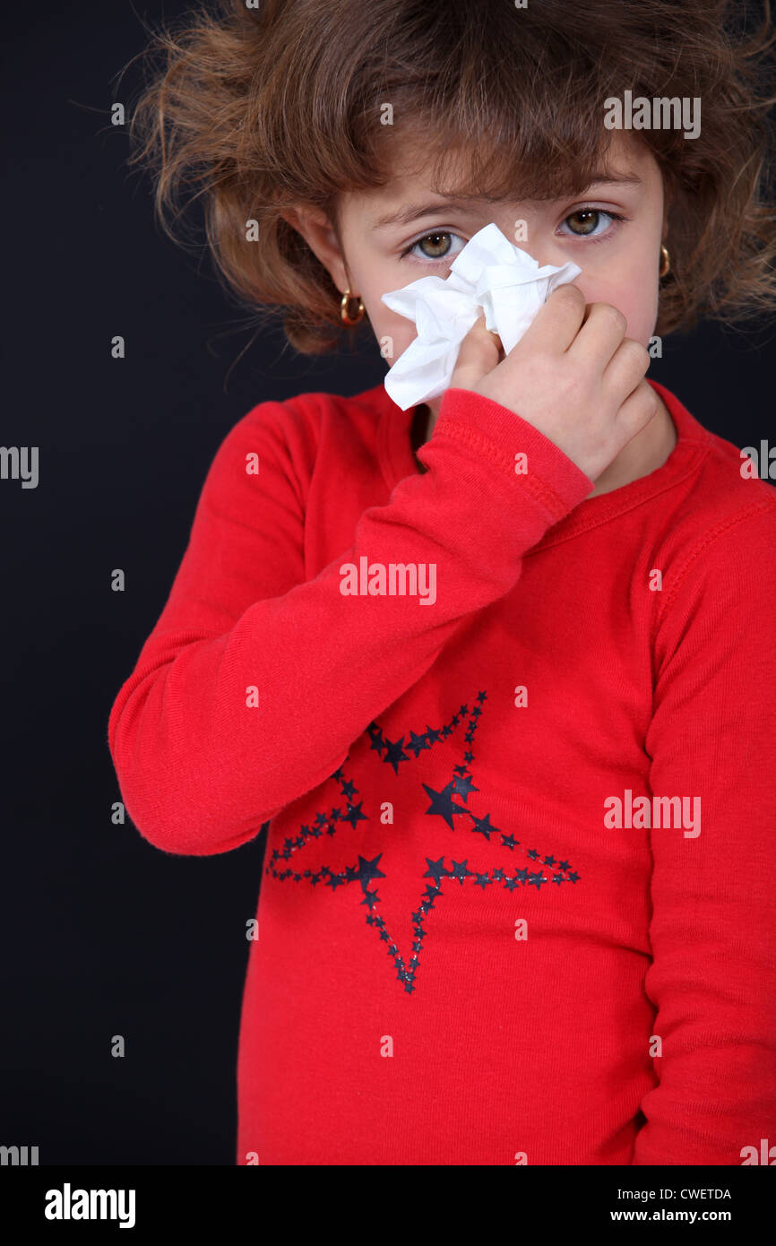 Girl blowing her nose Stock Photo - Alamy