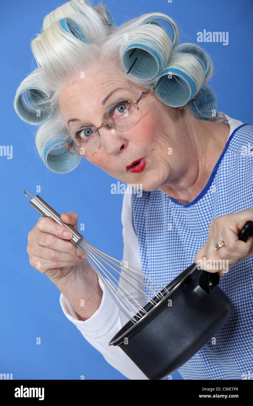 senior woman with curlers in her hair cooking Stock Photo - Alamy