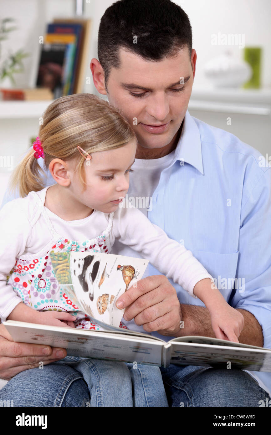 Father reading to daughter Stock Photo - Alamy