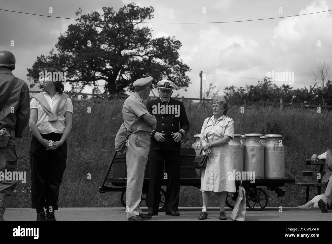 Group of civilians and armed forces on railway platform Stock Photo - Alamy