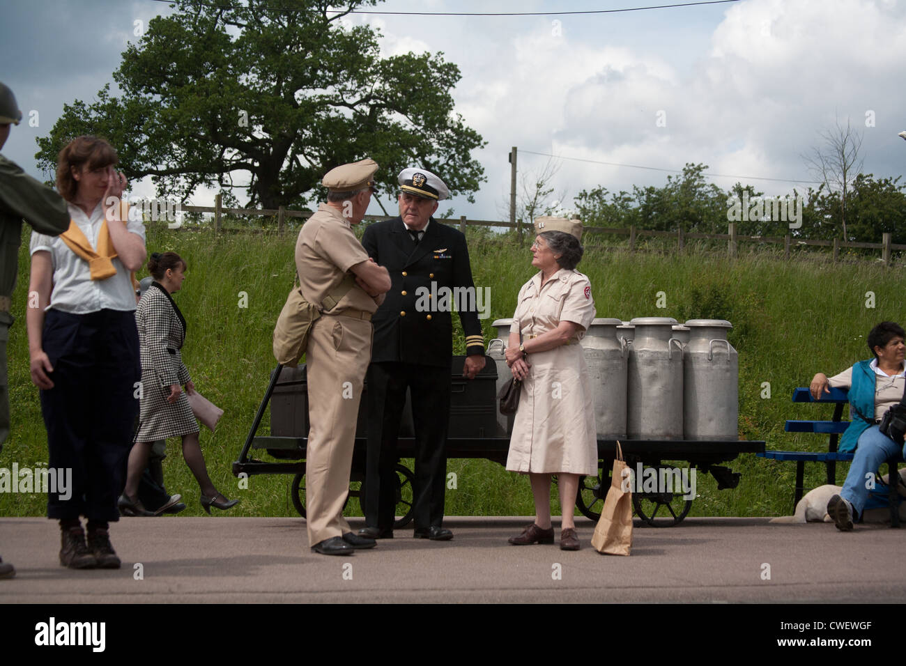 Group of civilians and armed forces on railway platform Stock Photo - Alamy