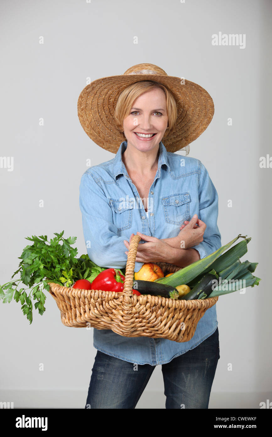 Woman with a vegetable basket Stock Photo - Alamy