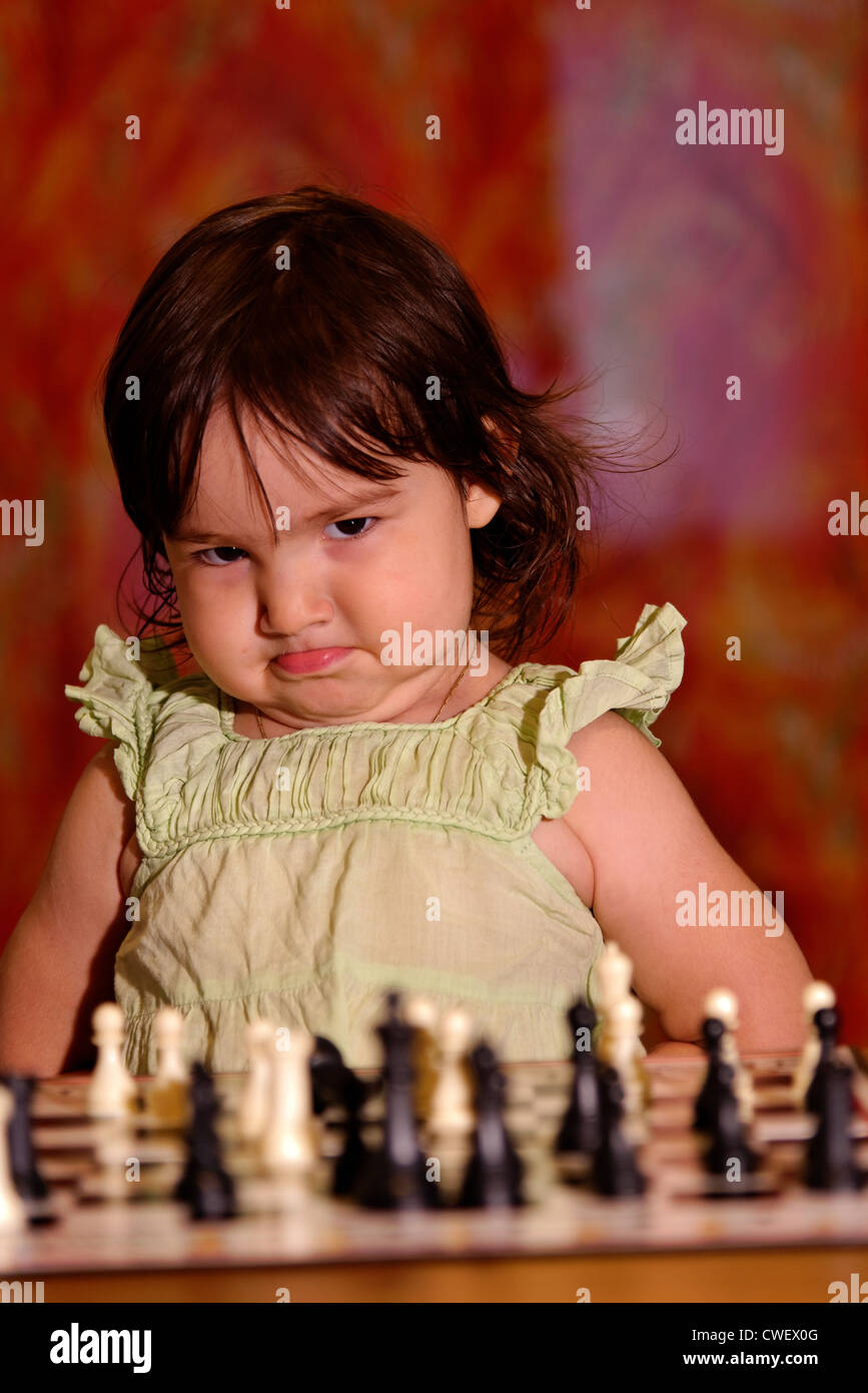 Toddler girl playing chess Stock Photo - Alamy