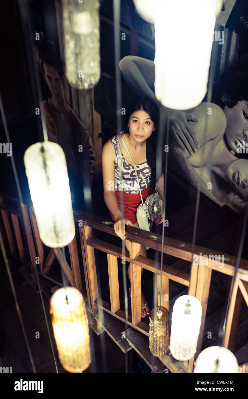 Portrait woman at stair with lamp light Stock Photo - Alamy