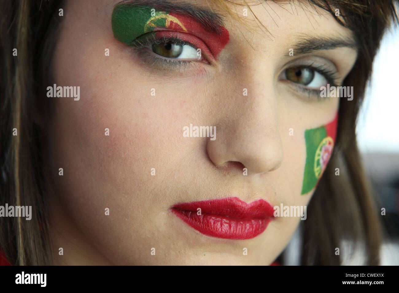 Attractive Portuguese woman with national flag painted on face Stock ...