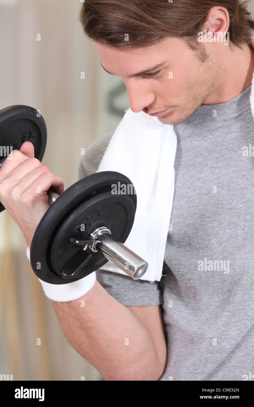 Man lifting dumbbell Stock Photo - Alamy