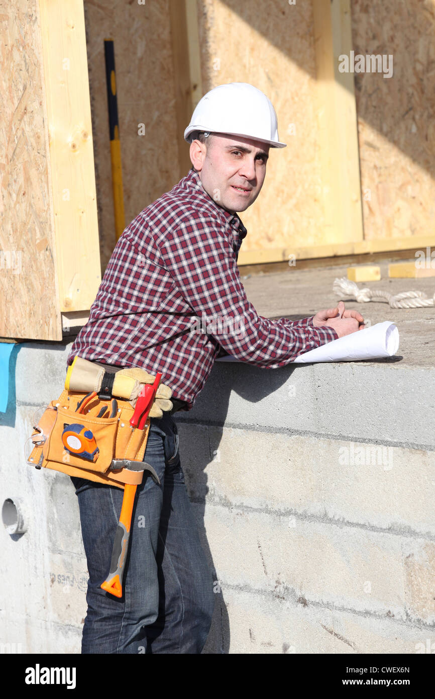 Foreman overseeing construction of wooden house Stock Photo - Alamy