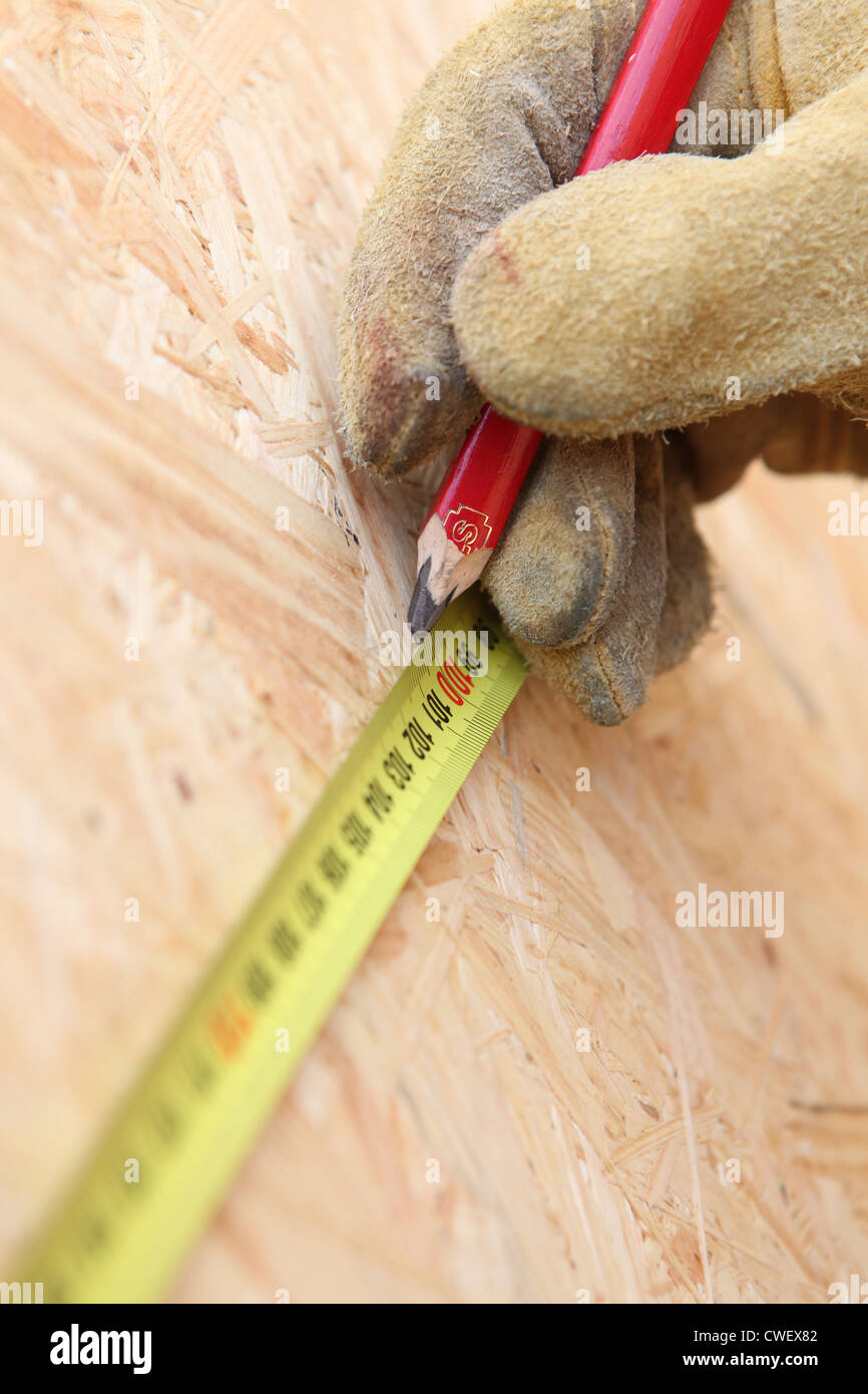 Carpenter marking plank of wood Stock Photo - Alamy