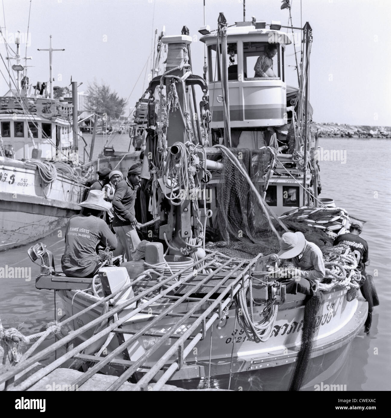 Thailand Commercial fishing boat at dock and fisherman working aboard ...