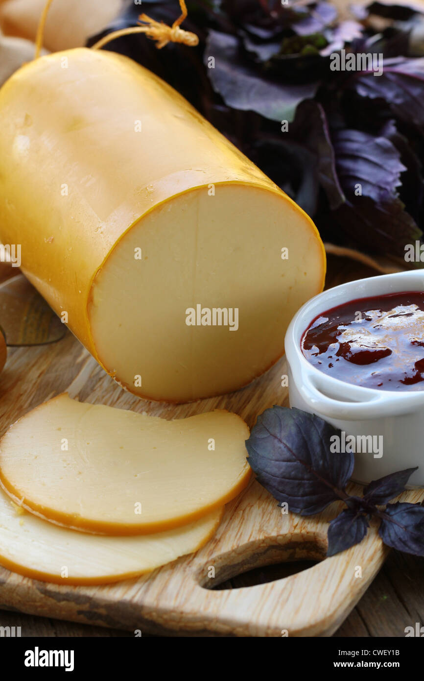 Smoked cheese with jam and fresh herbs Stock Photo - Alamy