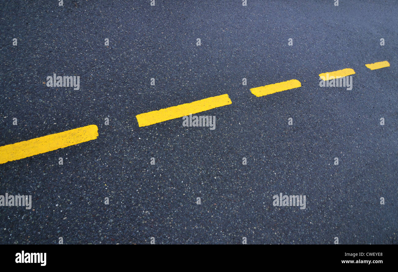 Abstract detail of asphalt road with yellow strip Stock Photo - Alamy
