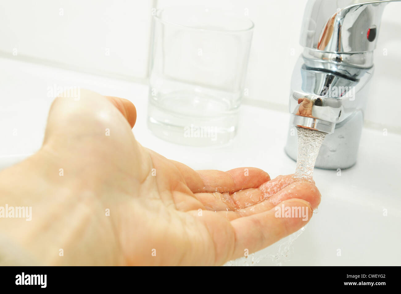 Detail of hand and water tap Stock Photo - Alamy