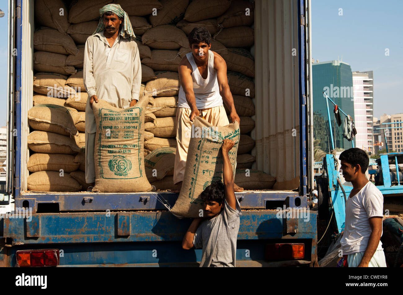 Dockers discharging a load of groundnut kernel bags from India in the ...