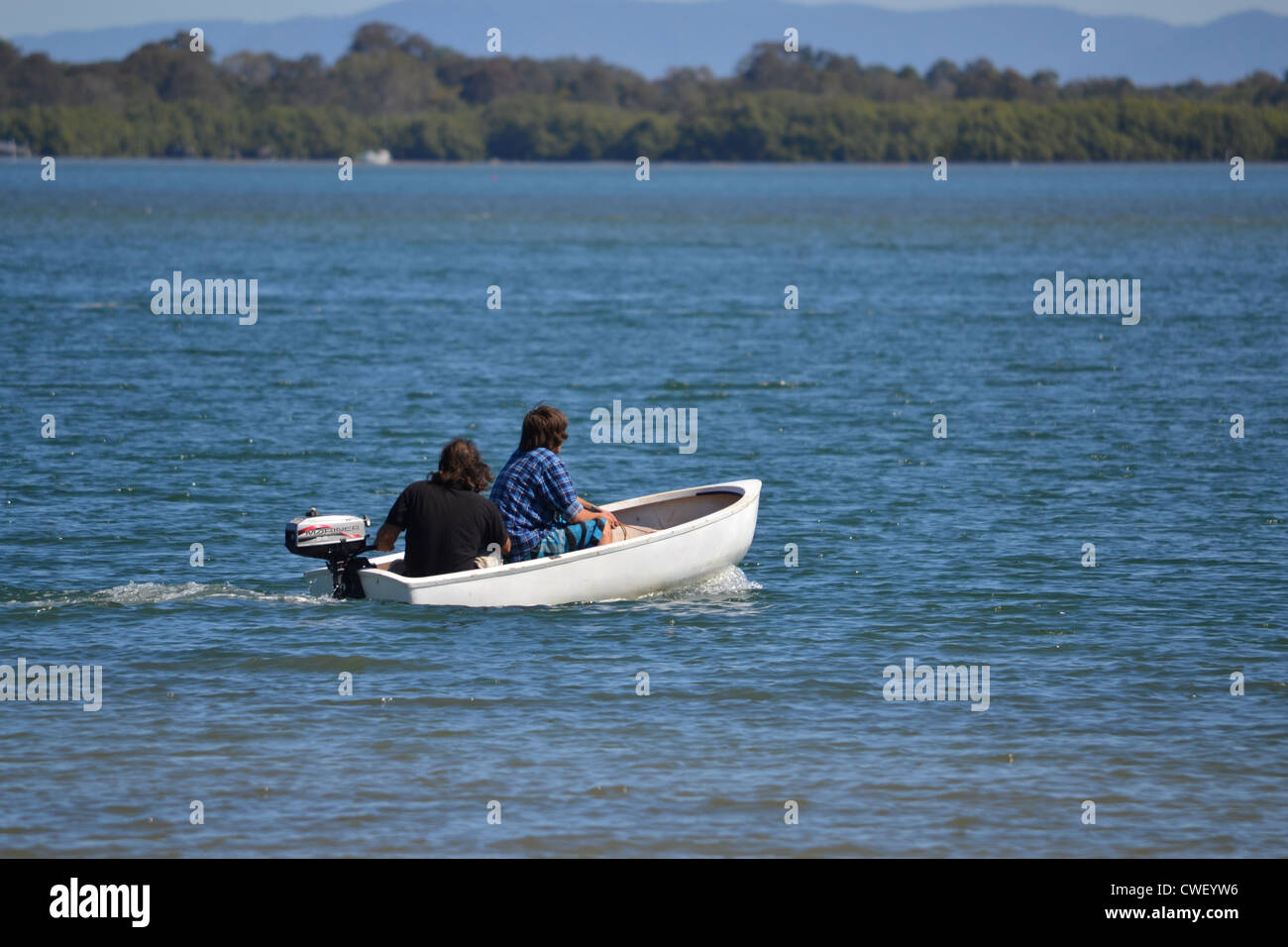 father and son go for ride in small boat Stock Photo - Alamy