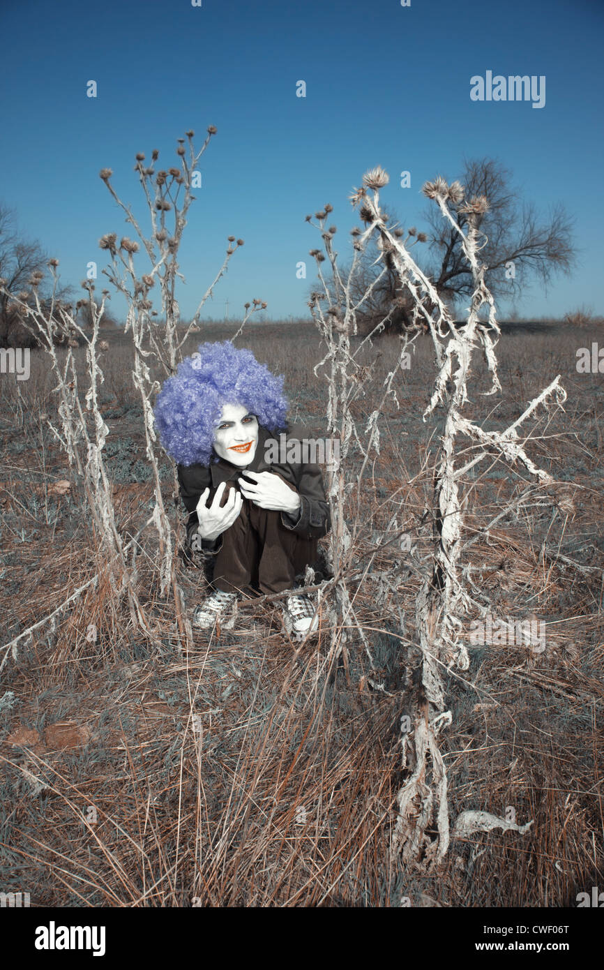 Crazy evil clown sitting outdoors Stock Photo - Alamy