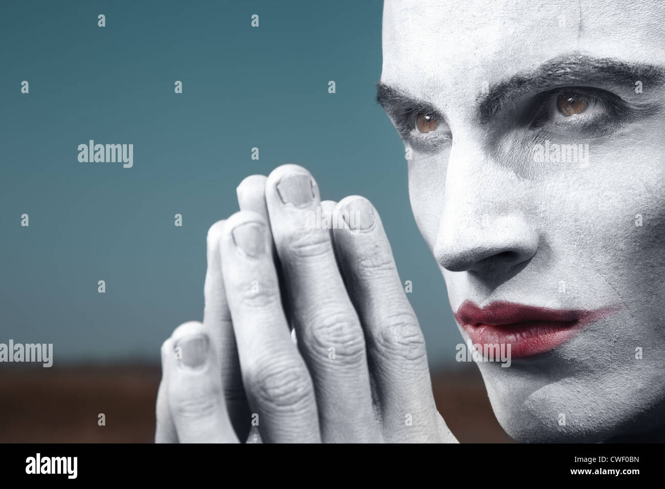 Angry vampire praying outdoors. Horizontal photo, special colors and ...