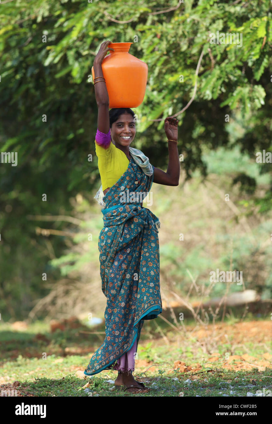 Woman carrying water jars hi-res stock photography and images - Alamy