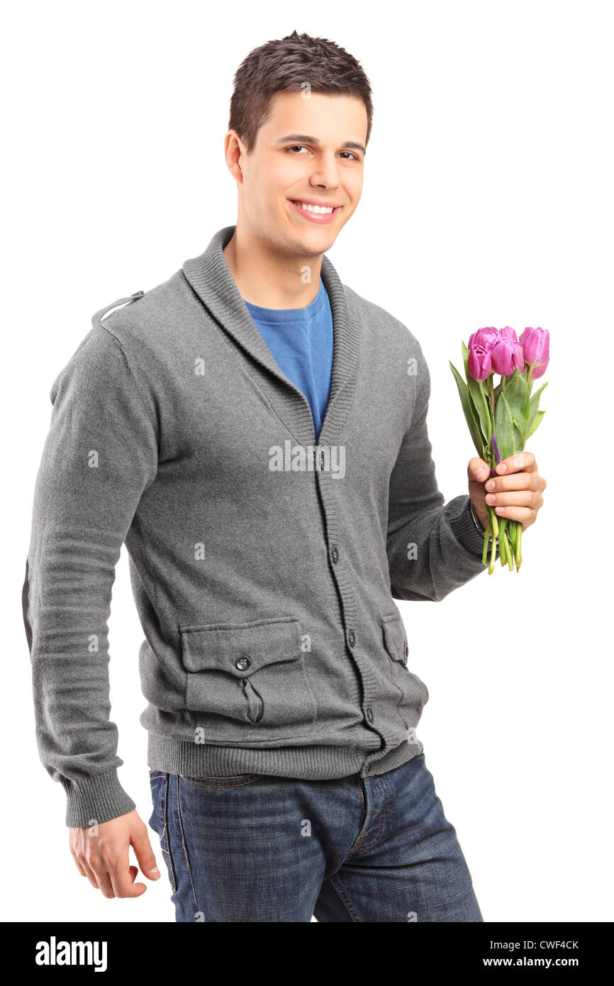 Handsome young man holding tulips isolated against white background ...