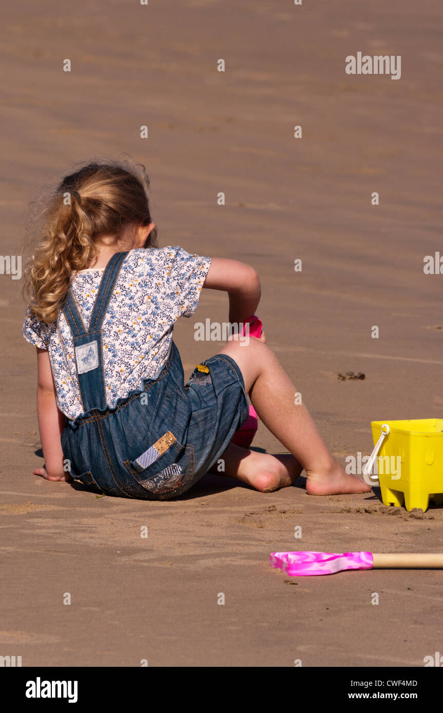 Little Girl Child Playing On A Sandy Beach With A Bucket and Spade UK ...