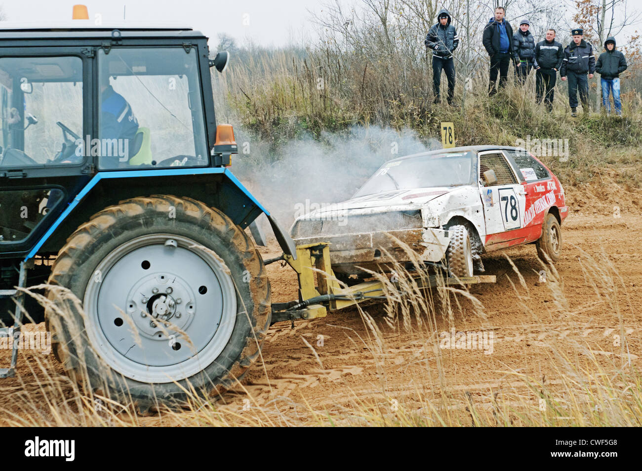 The tractor started to tow the racing car damaged by fire Stock Photo ...