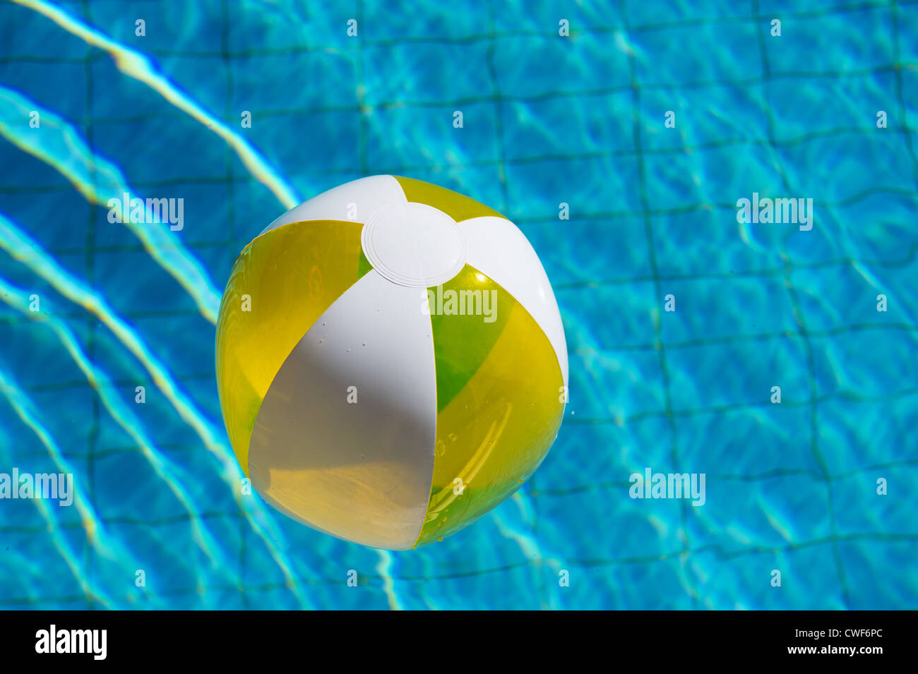 Inflatable yellow beachball floating at the water Stock Photo - Alamy