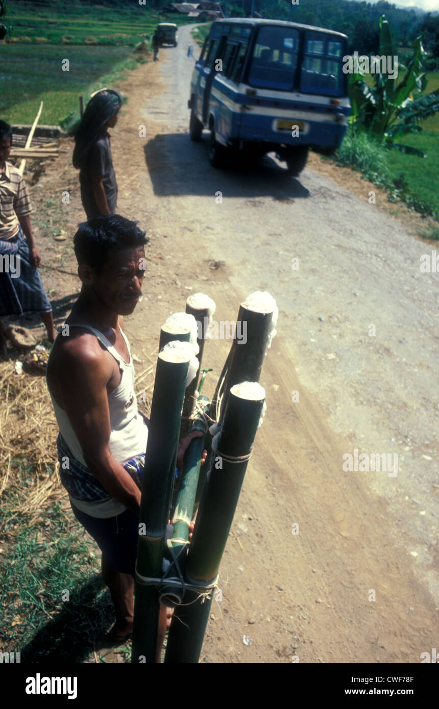 Farmer selling rice wine in bamboo by the road in Sulawesi Indonesia ...