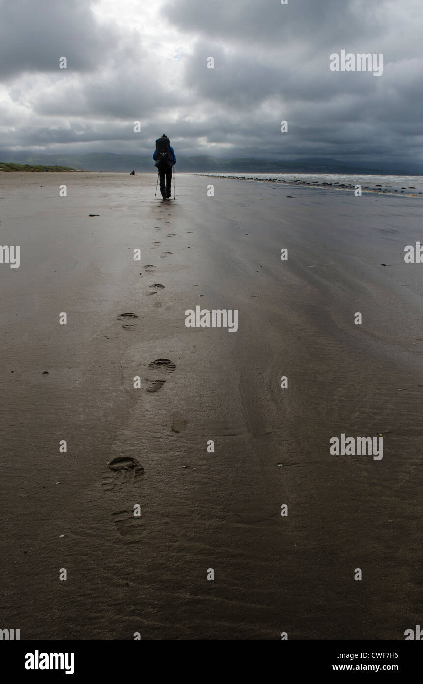lone figure walks along beach, wales Stock Photo - Alamy