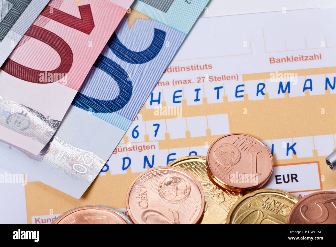 Completed Payment form with coins and banknotes Stock Photo - Alamy