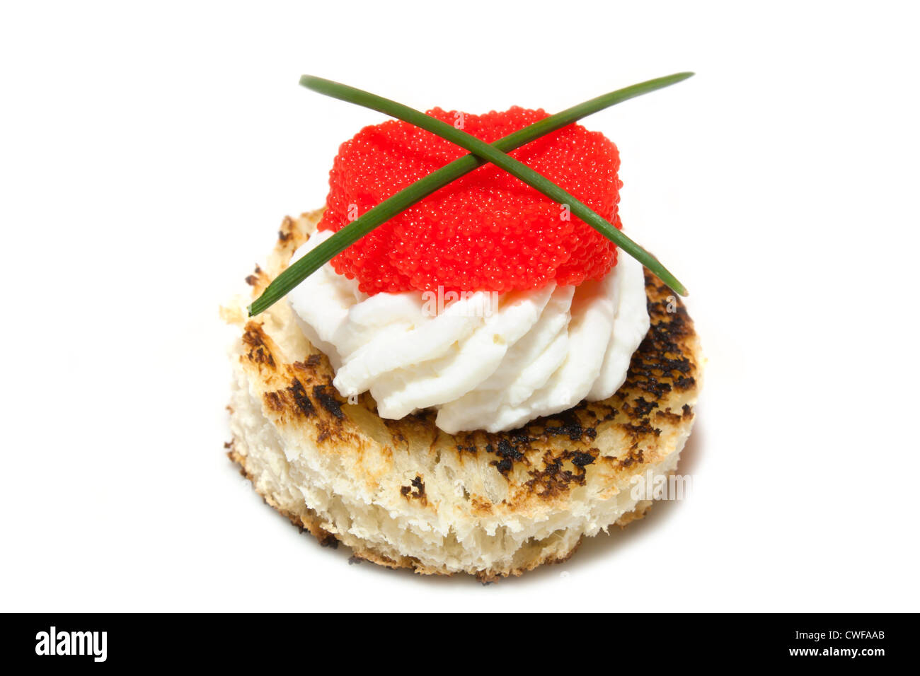 Red and black caviar canapés decorated with chives, on white background ...