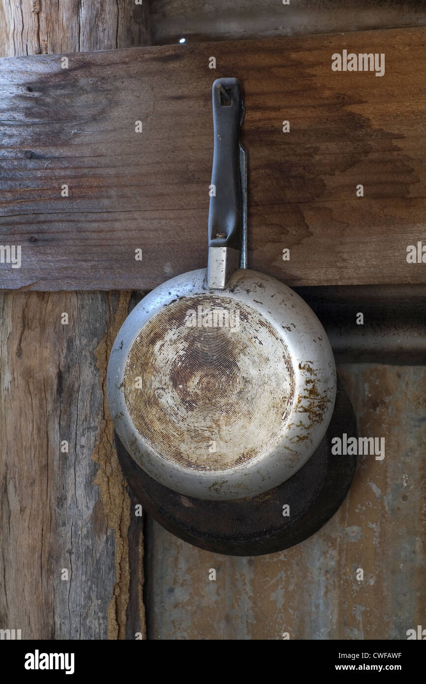 Rusty old saucepan hanging on the wall of a wooden shack Stock Photo ...