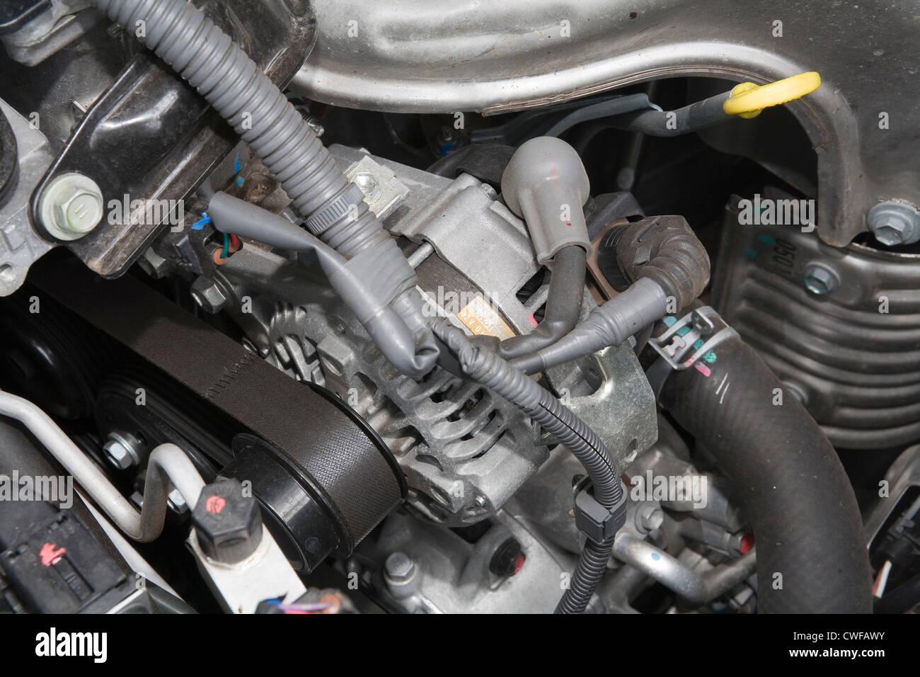 Alternator positioned in the engine bay of a car Stock Photo - Alamy