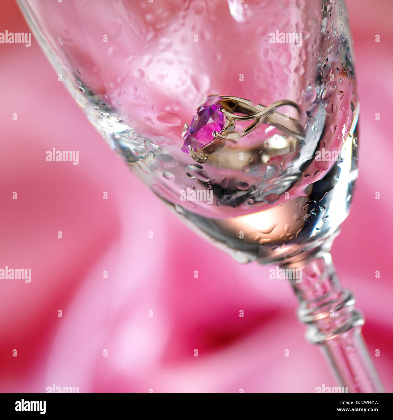 pink ring in a transparent champagne cup Stock Photo - Alamy