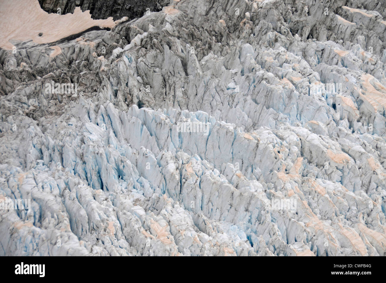 Deep crevasses form at the top of the12 km long Franz Josef Glacier set ...
