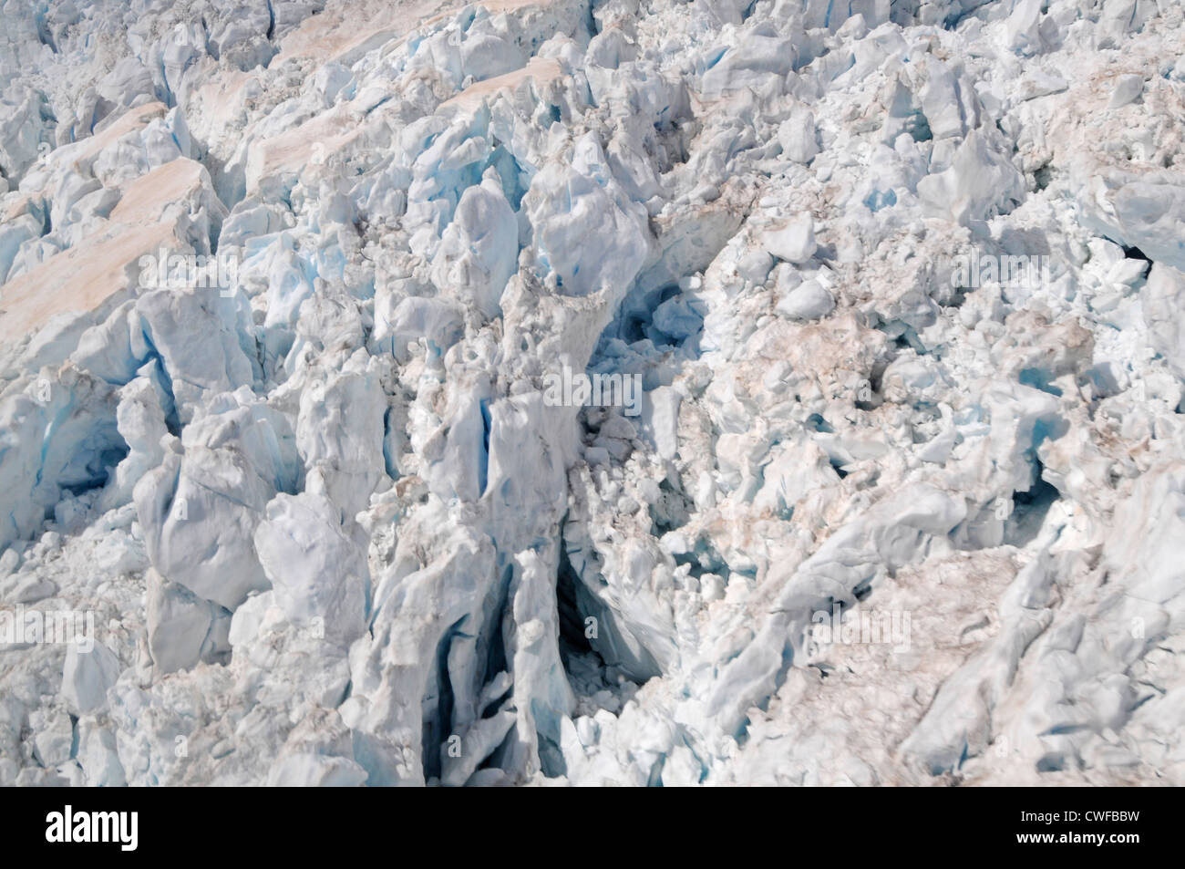 Deep crevasses form at the top of the12 km long Franz Josef Glacier set ...