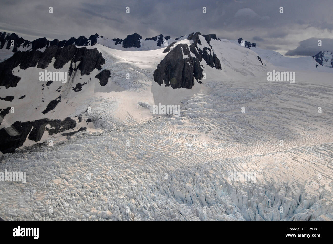 Deep crevasses form at the top of the12 km long Franz Josef Glacier set ...