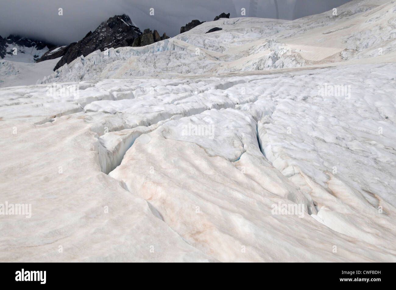 Deep crevasses form at the top of the12 km long Franz Josef Glacier set ...
