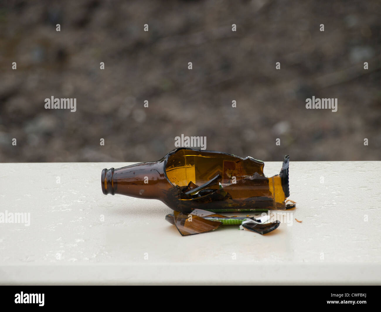 Broken beer bottle on bench Stock Photo - Alamy