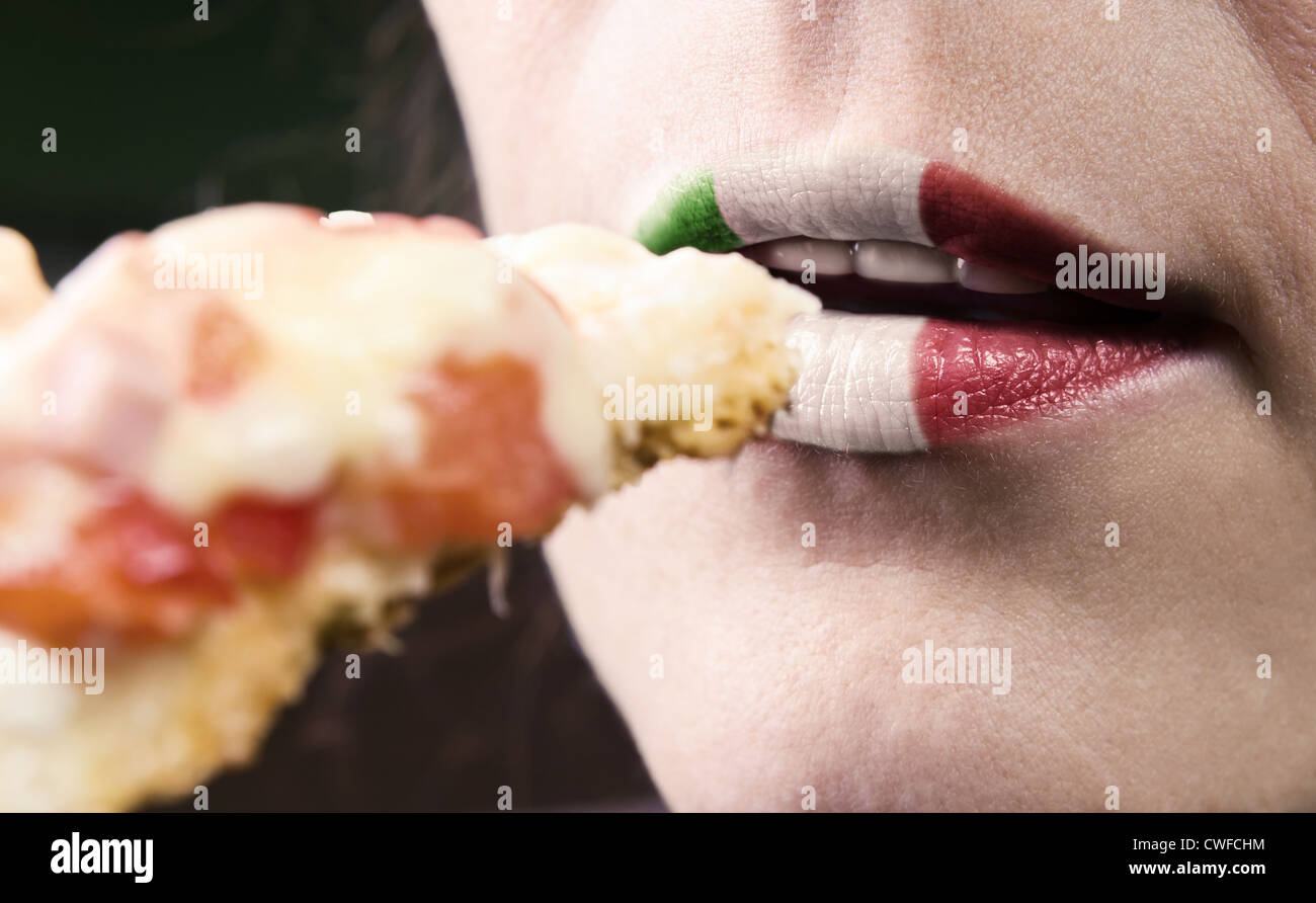 The Italian woman eats pizza. Focus on a lips Stock Photo - Alamy