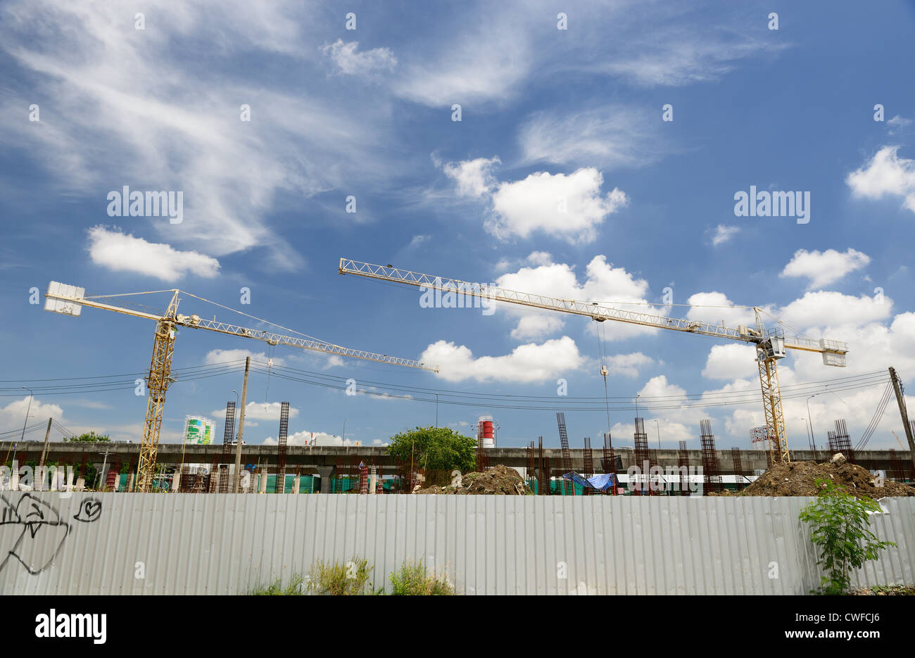 The crane is building construction behind the fence Stock Photo - Alamy