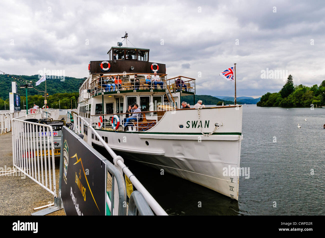 Passengers board the historic steamer (now diesel) MV Swan for a trip ...