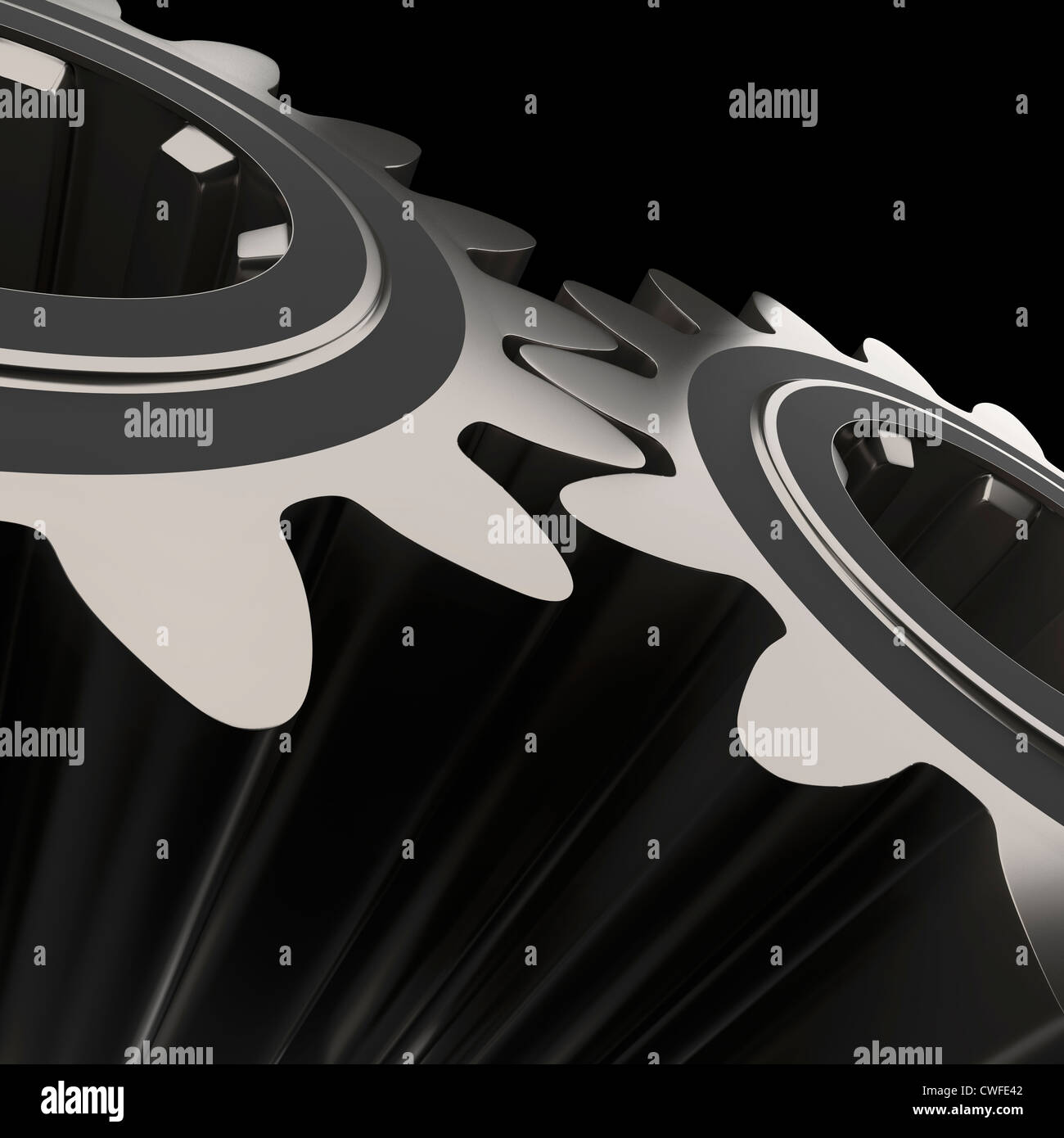 Two metal gears meshing together on black background Stock Photo - Alamy