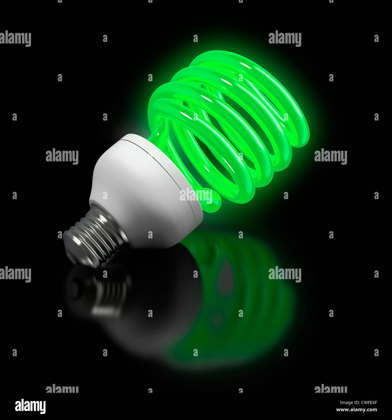 Economic fluorescent ecological light bulb on lying on black background ...