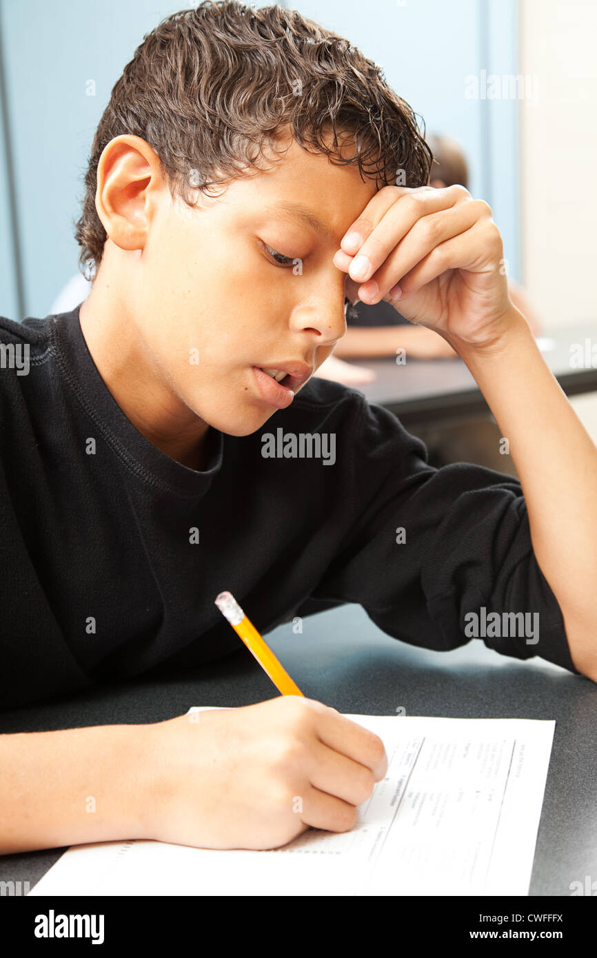 Handsome school boy struggling to finish a test in class Stock Photo ...