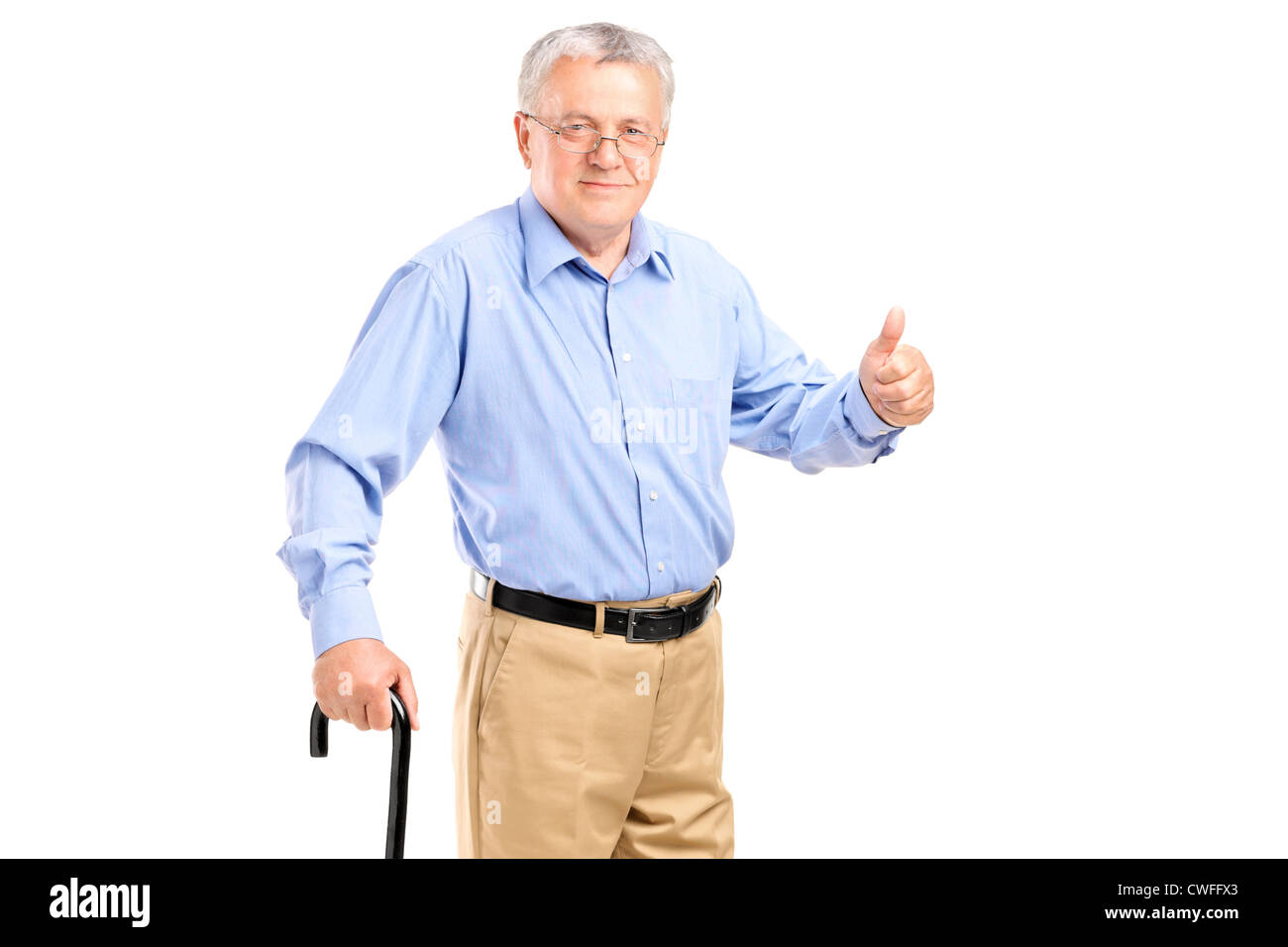 A senior man holding a cane and giving thumb up isolated on white ...
