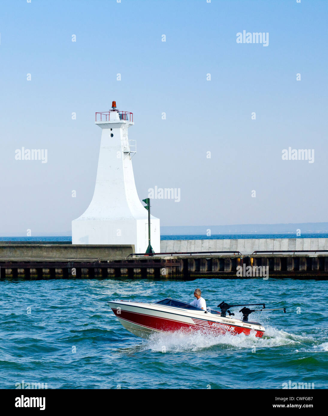 Boat and a lighthouse Stock Photo - Alamy