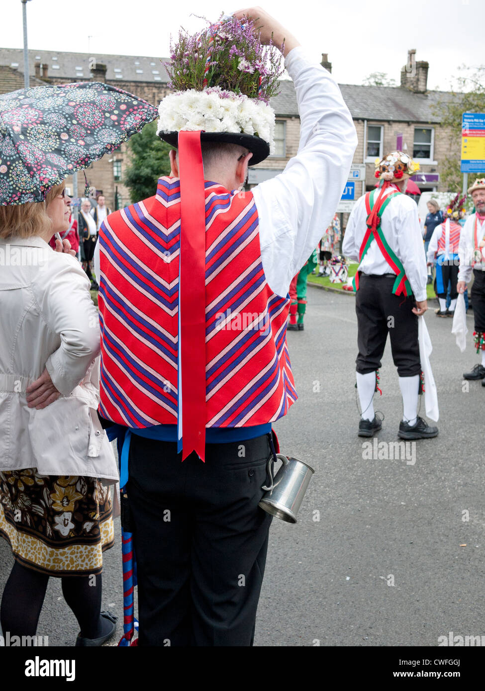 Morris dancer adjusting his hat, Uppermill, Greater Manchester, UK ...