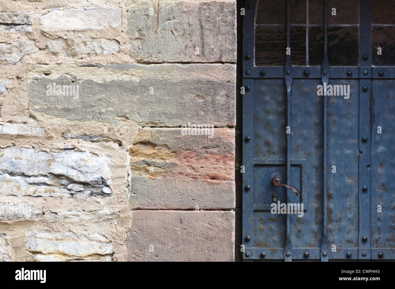 Medieval iron gate and sandstone brick wall of a historic building in ...